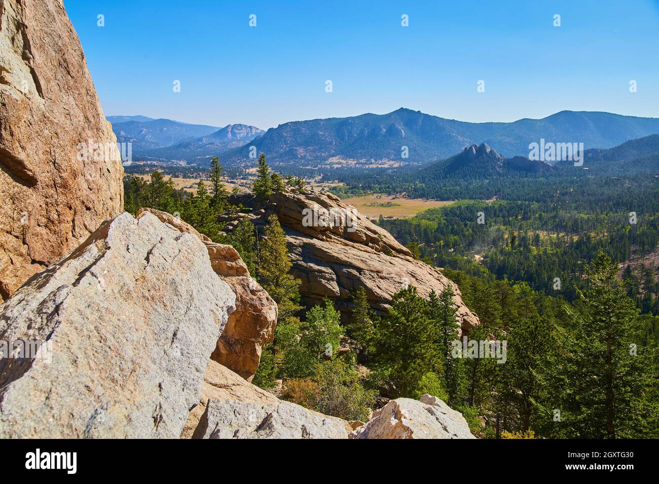 Landscape of large boulders in mountain with valley of pine trees Stock ...