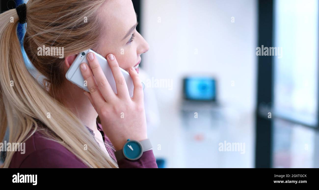 female manager using cell telephone in office interior Stock Photo - Alamy