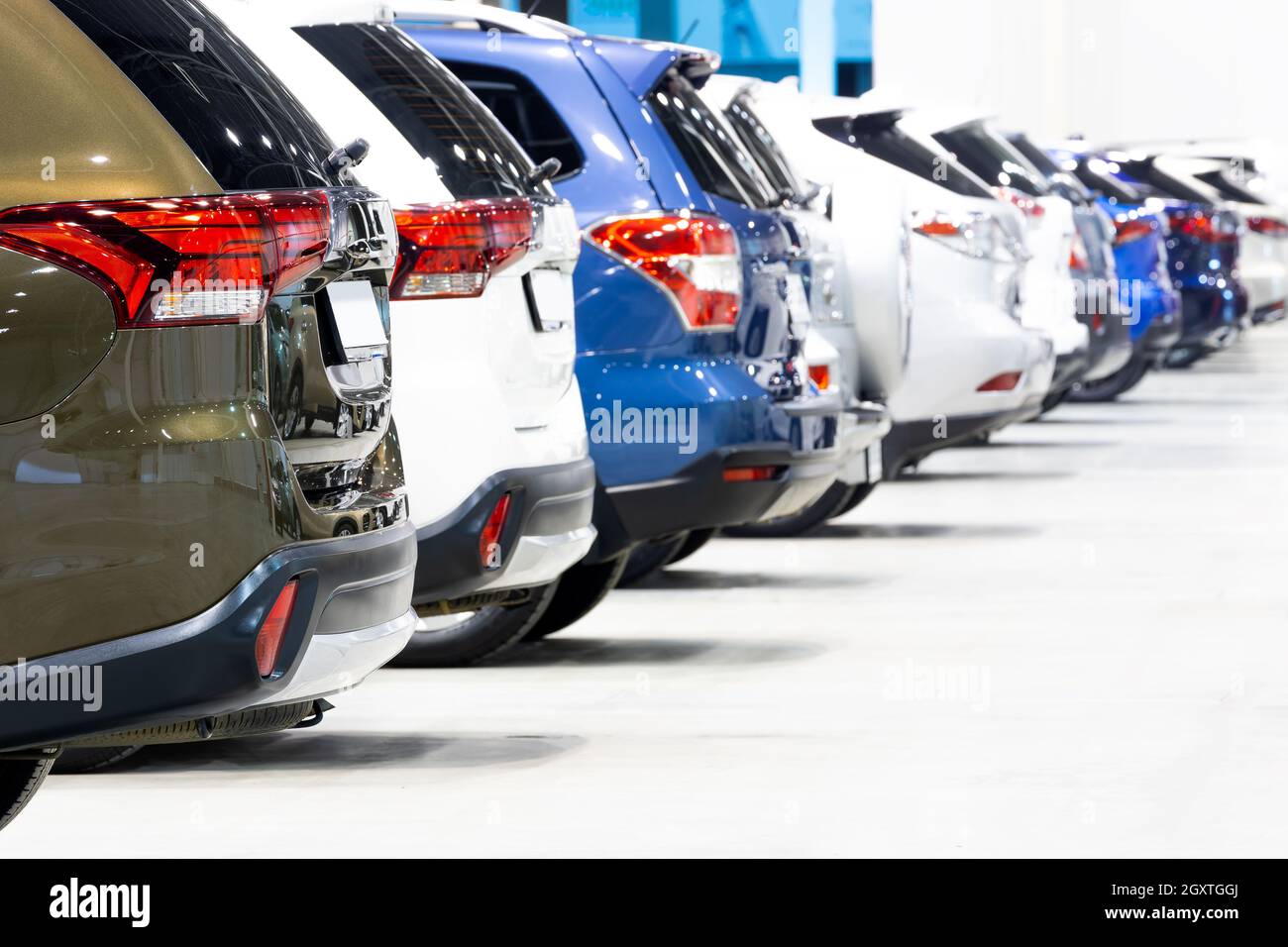 close-up of a car dealership rows of urban crossovers for sale, rear ...