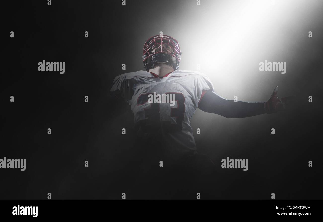 american football player celebrating after scoring a touchdown on field ...