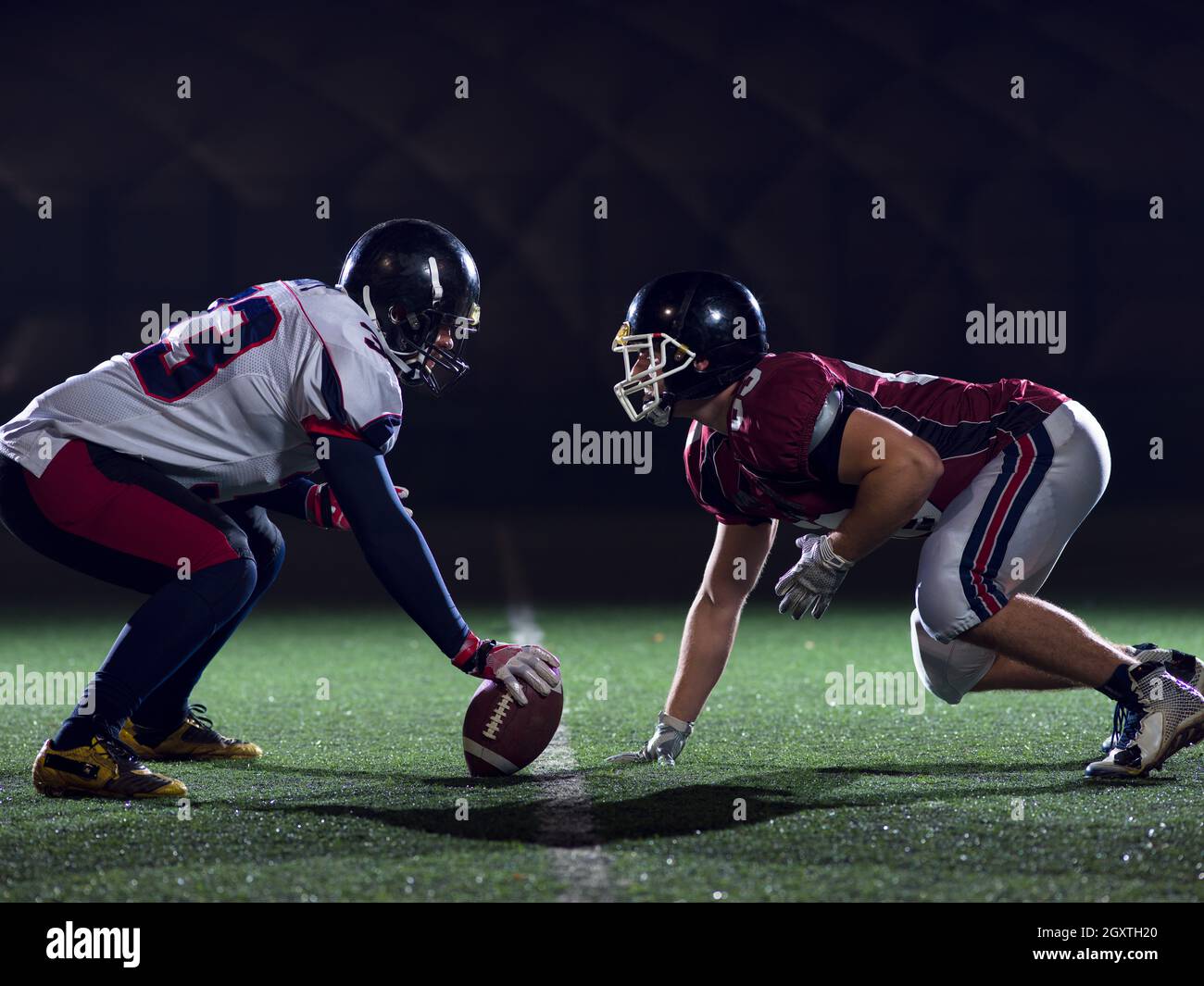 american football players are ready to start on field at night Stock ...