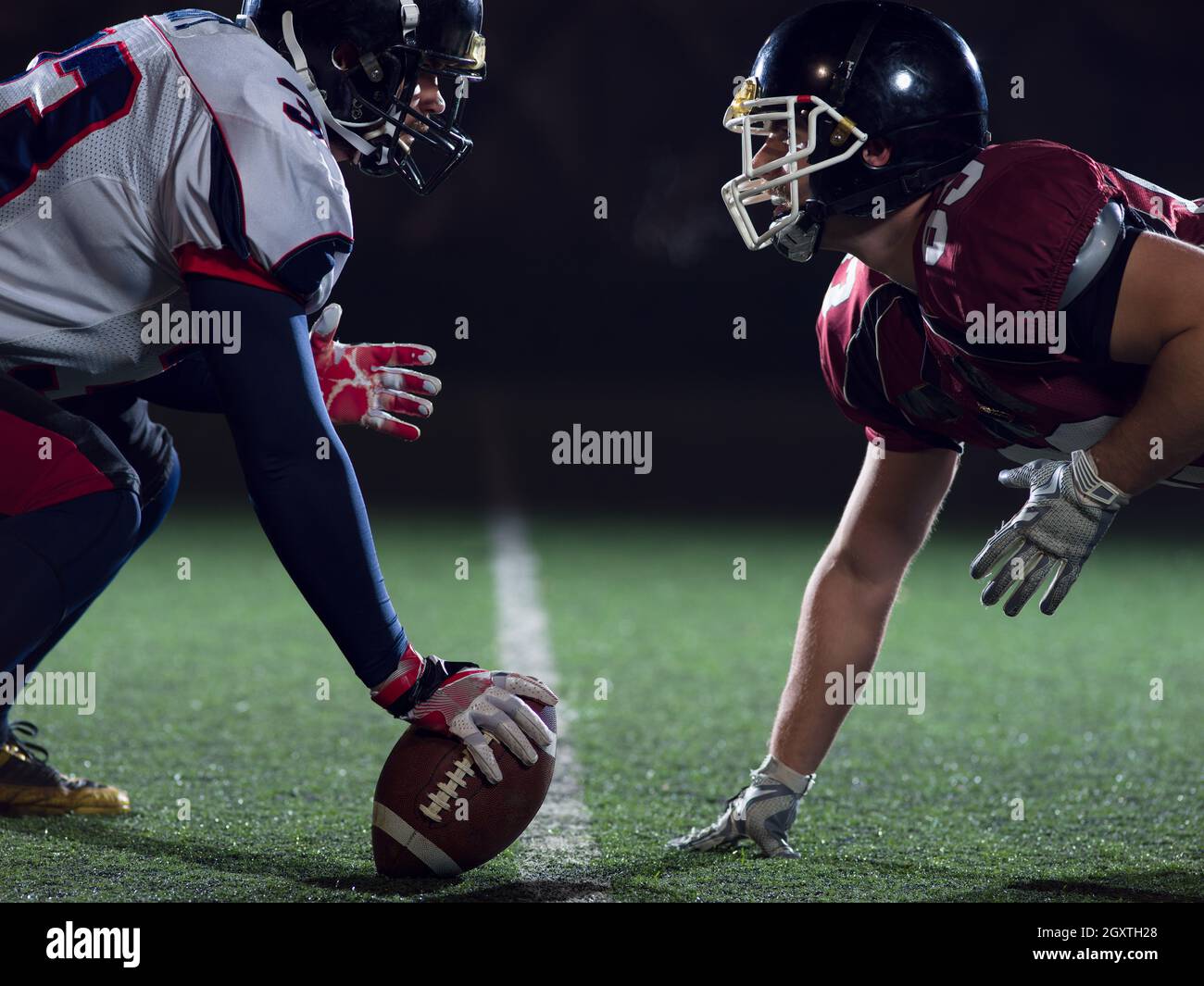 american football players are ready to start on field at night Stock ...