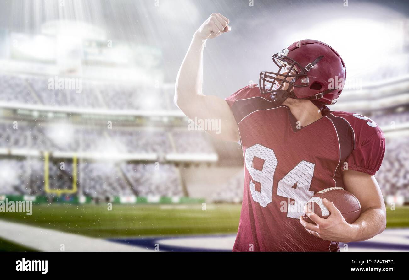 american football player celebrating touchdown on big modern stadium ...