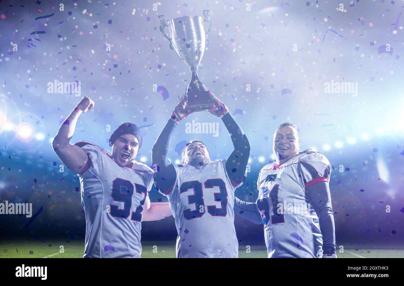 happy american football team with trophy celebrating victory in the cup ...