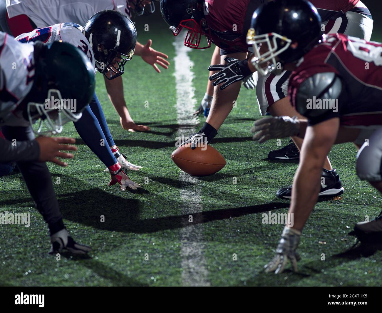 american football players are ready to start on field at night Stock ...