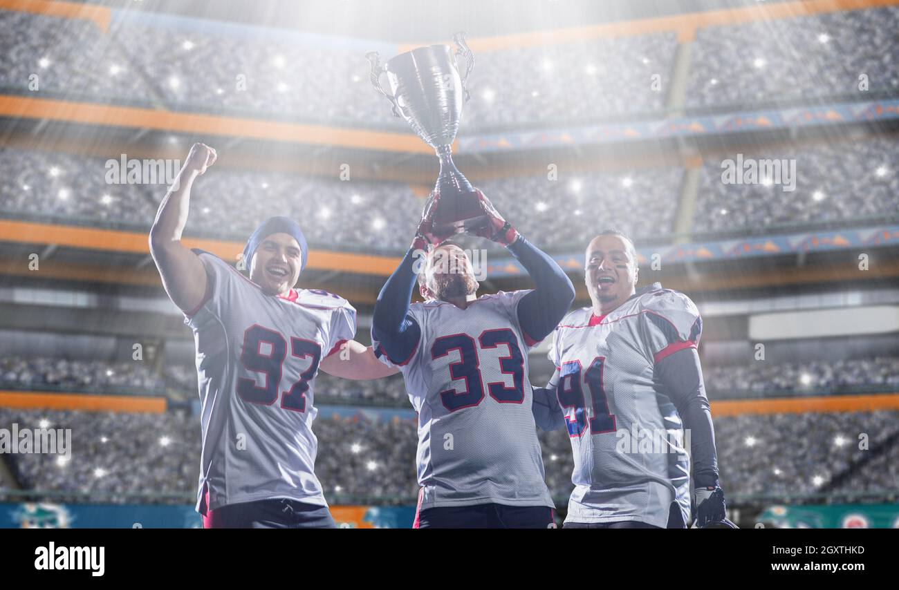 happy american football team with trophy celebrating victory in the cup ...