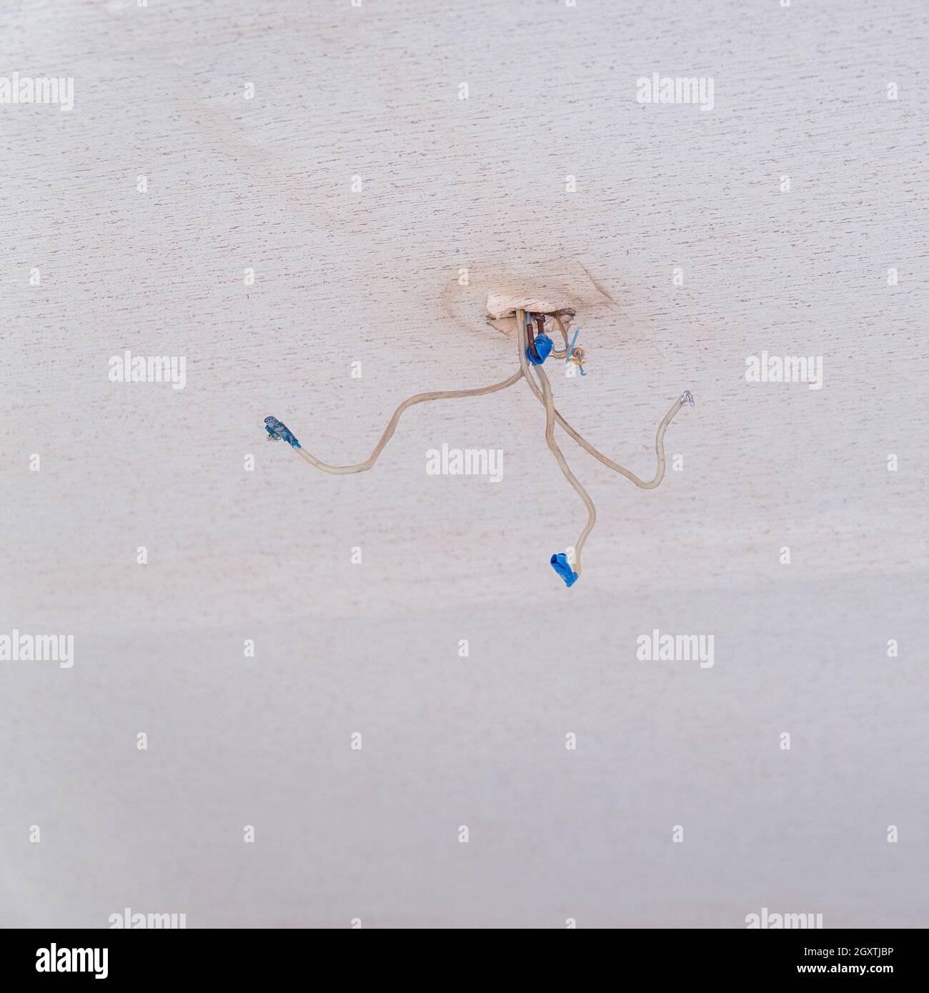 Dangerous bad wiring which hangs on the ceiling Stock Photo - Alamy