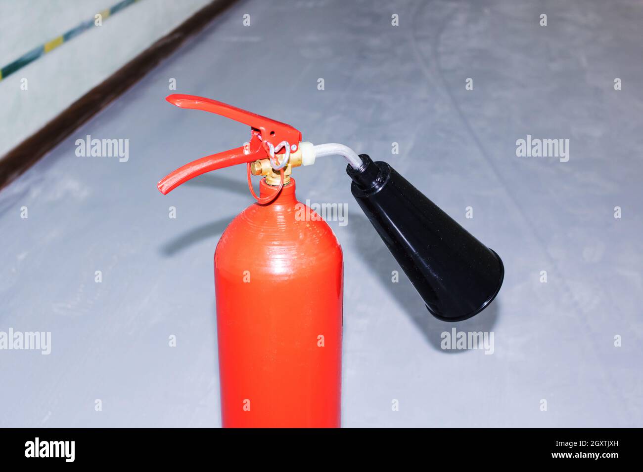 Red fire extinguisher in the room close up Stock Photo - Alamy