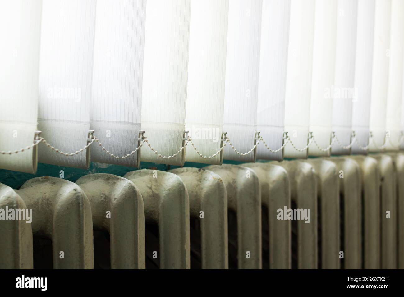 White blinds on the window above the radiator close up Stock Photo - Alamy