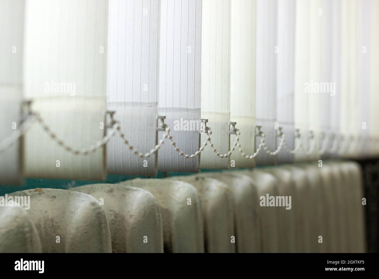 White blinds on the window above the radiator close up Stock Photo - Alamy
