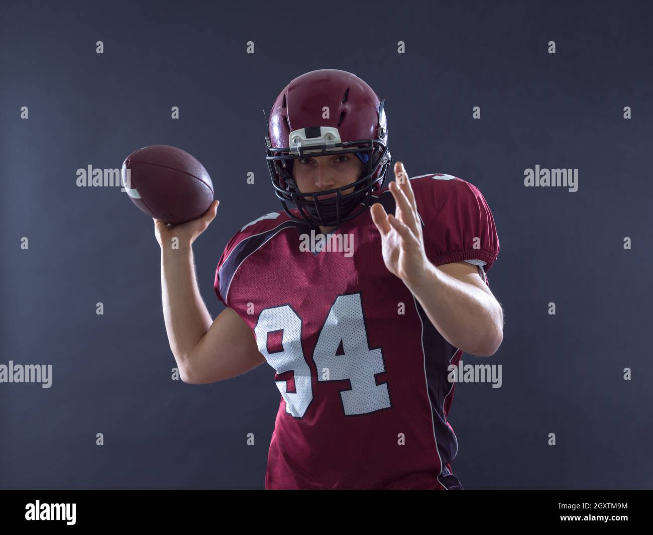 one quarterback american football player throwing ball isolated on gray ...