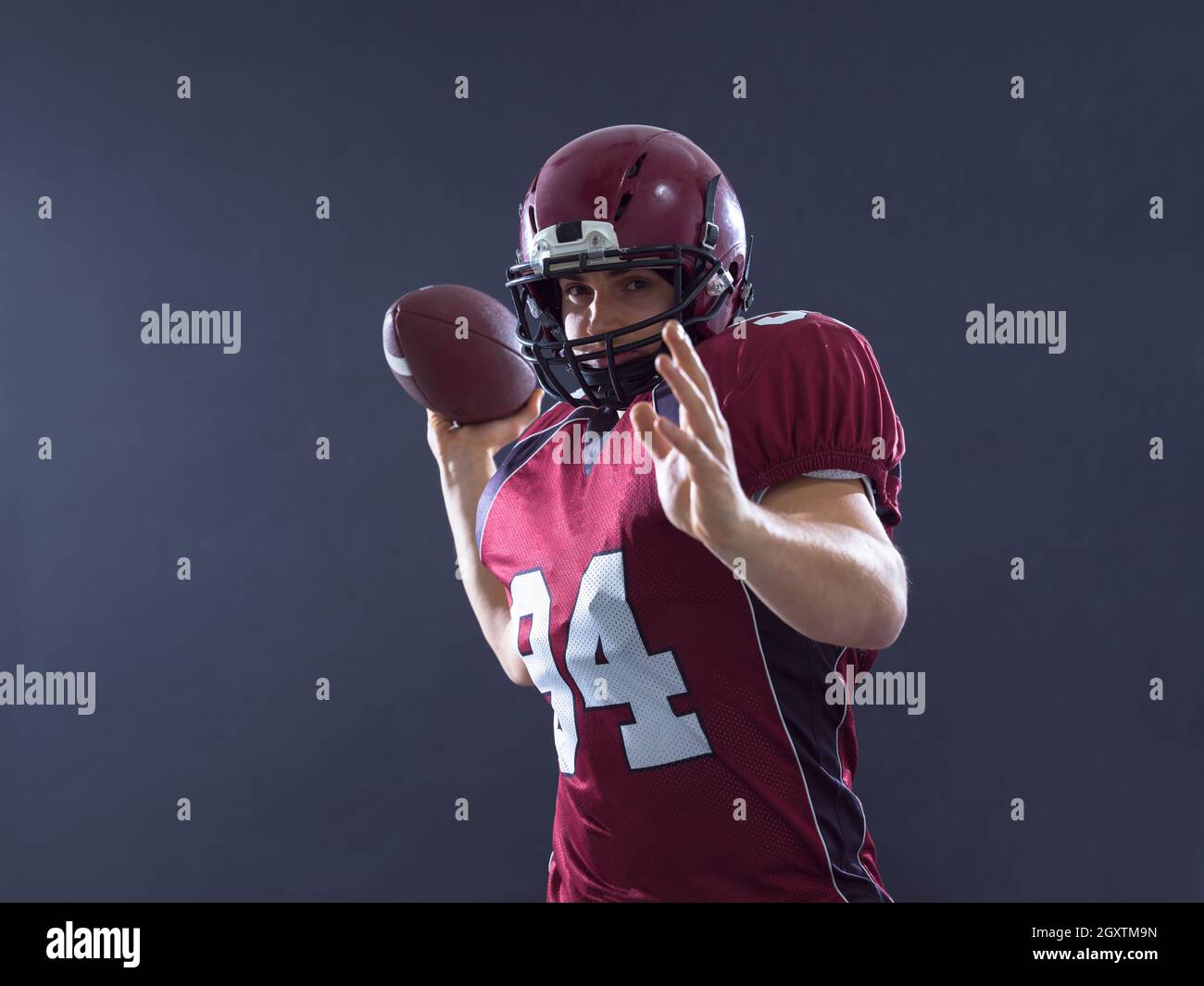 one quarterback american football player throwing ball isolated on gray ...