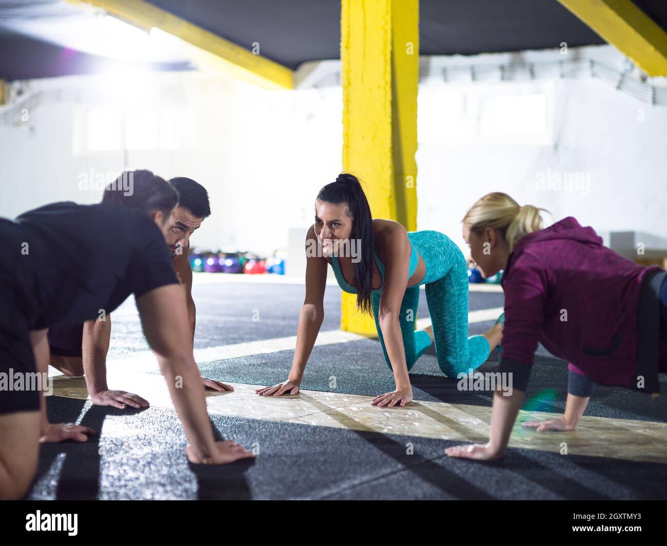 group of young healthy people doing pushups at crossfitness gym Stock ...