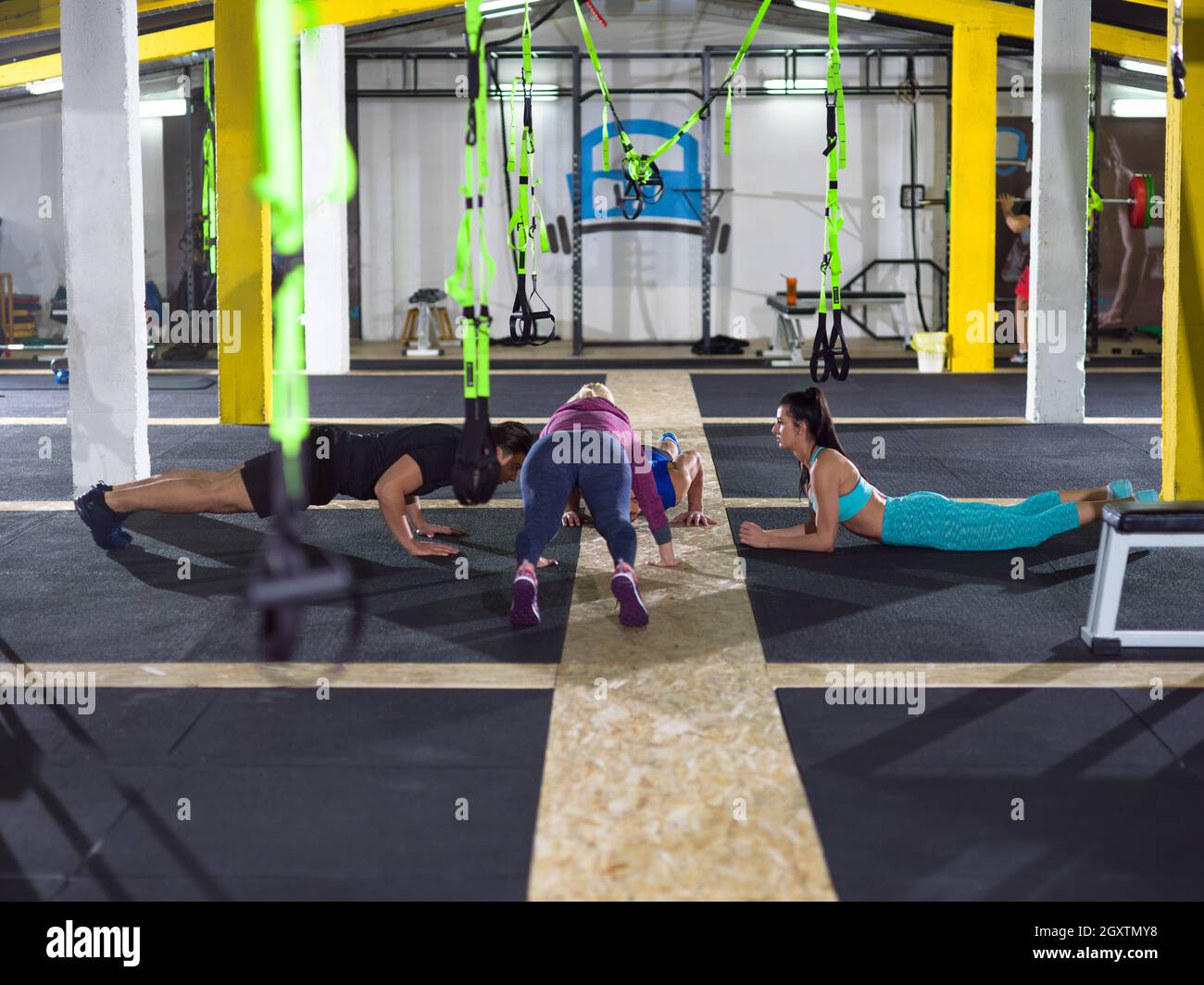 group of young healthy people doing pushups at crossfitness gym Stock ...