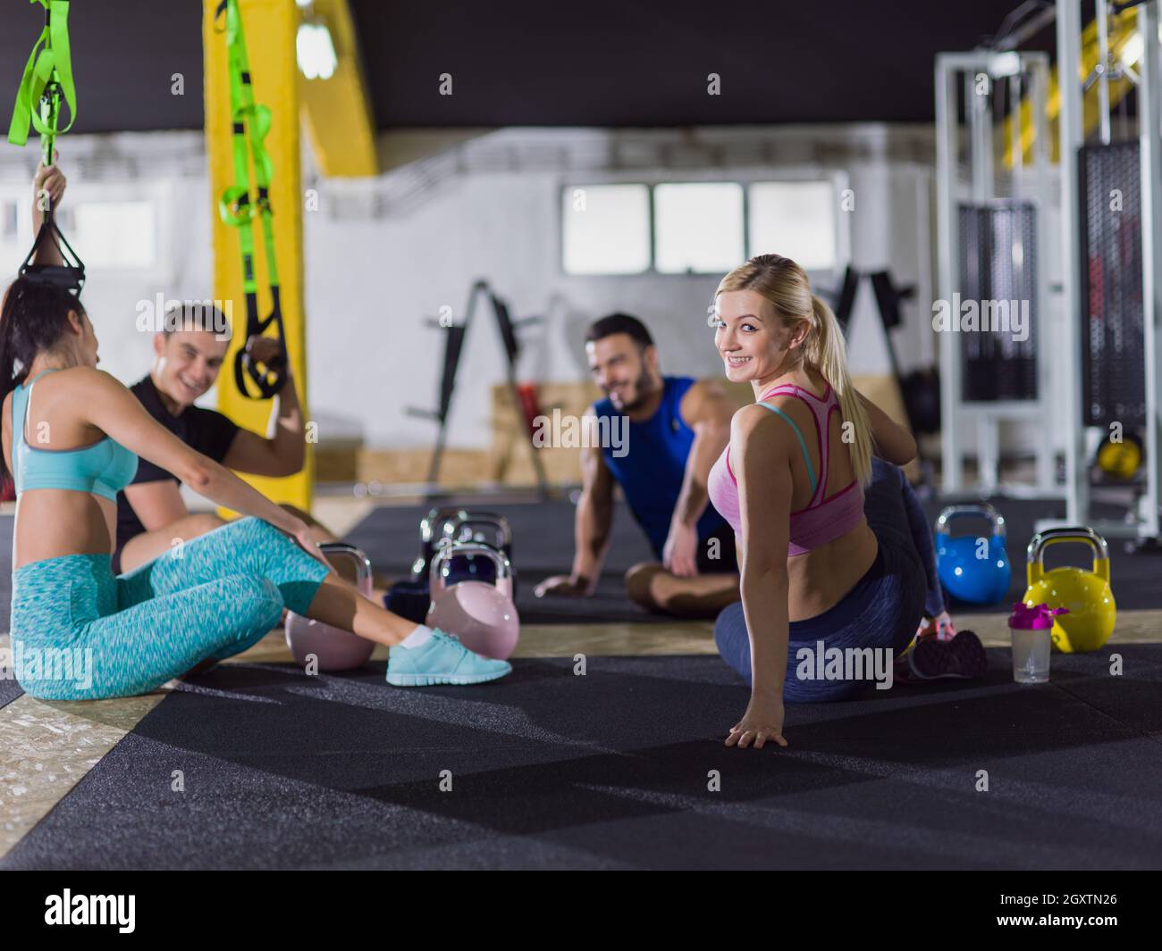 a group of young athletes sitting on the floor and relaxing after ...