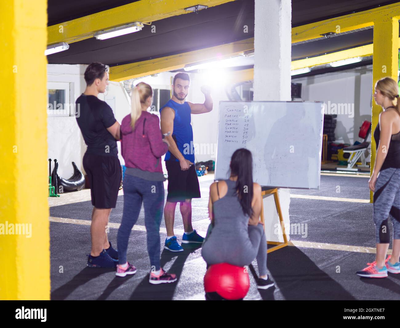 Crossfit training course.group of young athletes getting instructions ...