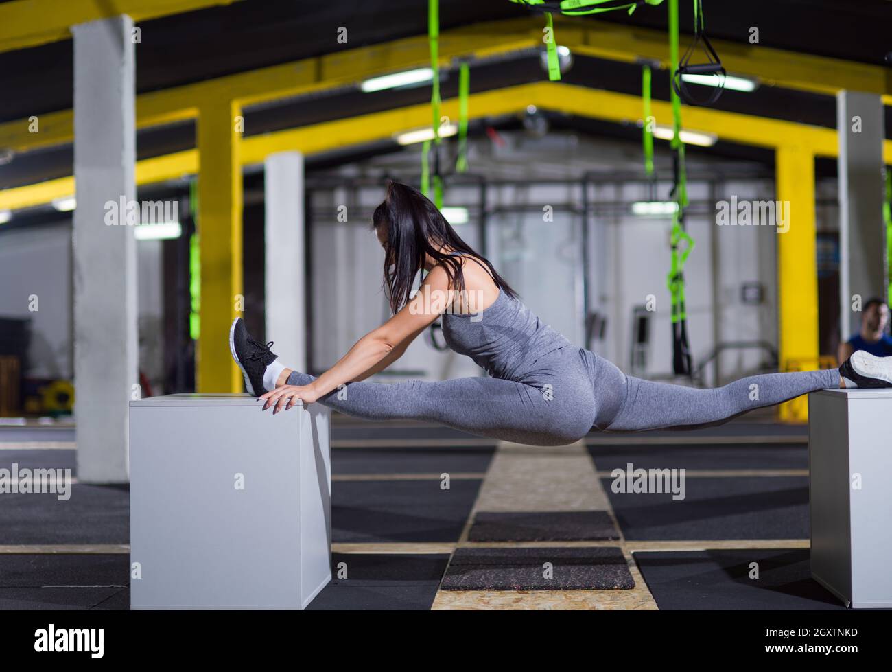 young athletic woman doing gymnastic exercise between two fit boxes at ...