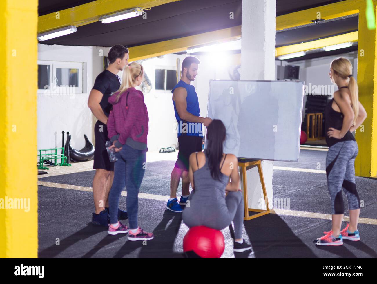 Crossfit training course.group of young athletes getting instructions ...
