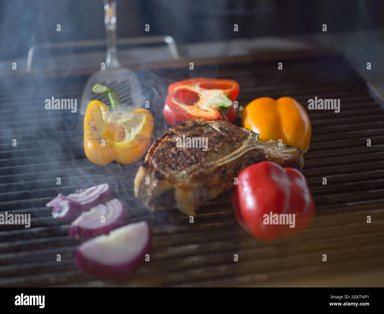 delicious grilled meat steak with vegetables on a barbecue Stock Photo ...