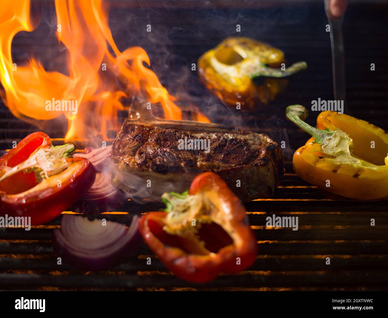 delicious grilled meat steak with vegetables on a barbecue Stock Photo ...