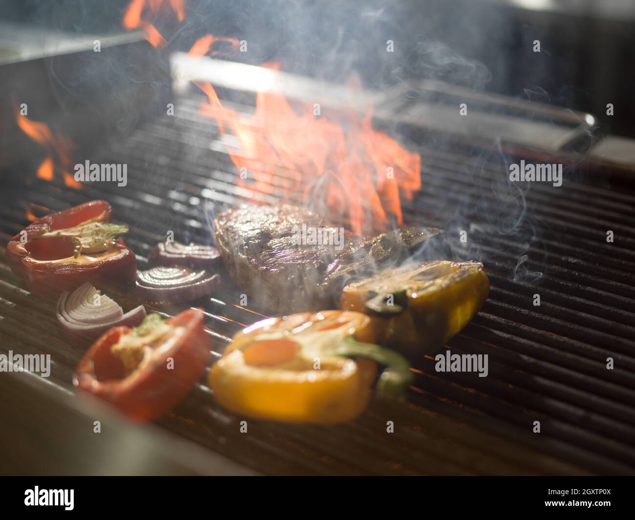 Master chef cooking delicious grilled meat steak with vegetables on a ...