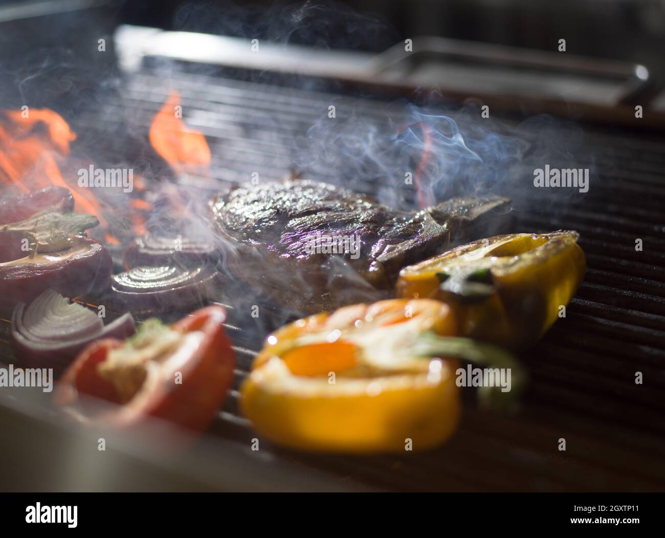 delicious grilled meat steak with vegetables on a barbecue Stock Photo ...