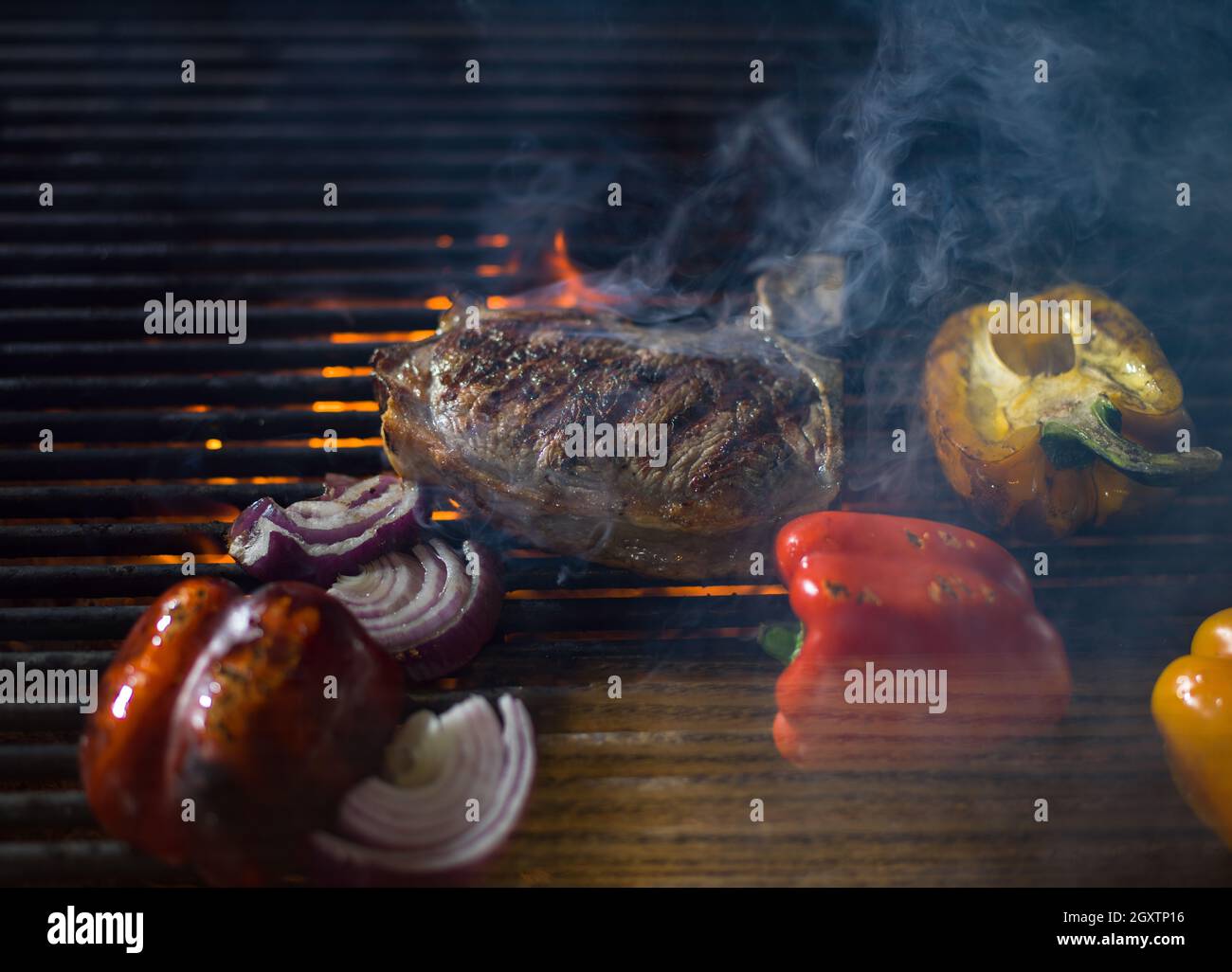 delicious grilled meat steak with vegetables on a barbecue Stock Photo ...