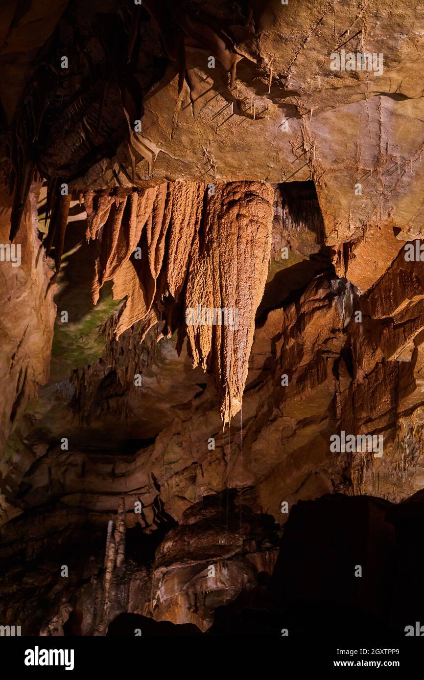 Vertical detail of cave formations with dripping water stalactites ...