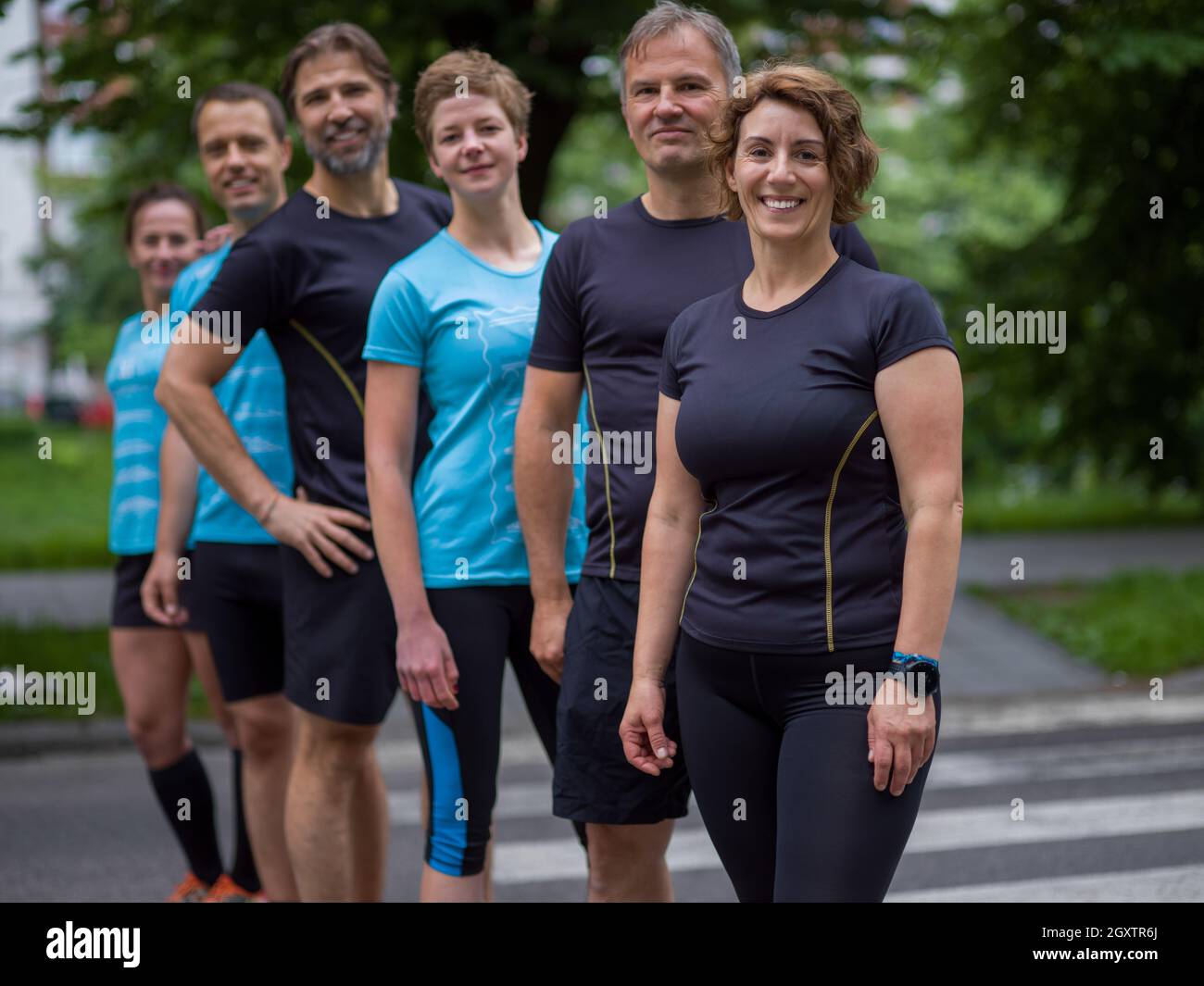portrait of a group healthy people jogging in city park, runners team ...