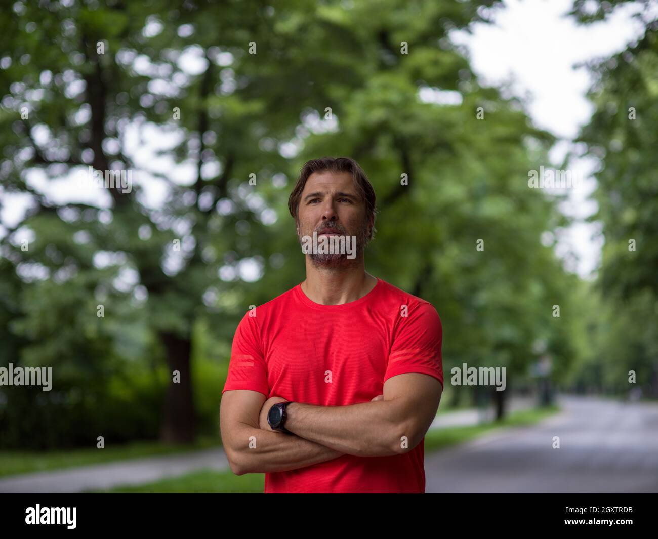 portrait of fit muscular male runner training for marathon running on ...