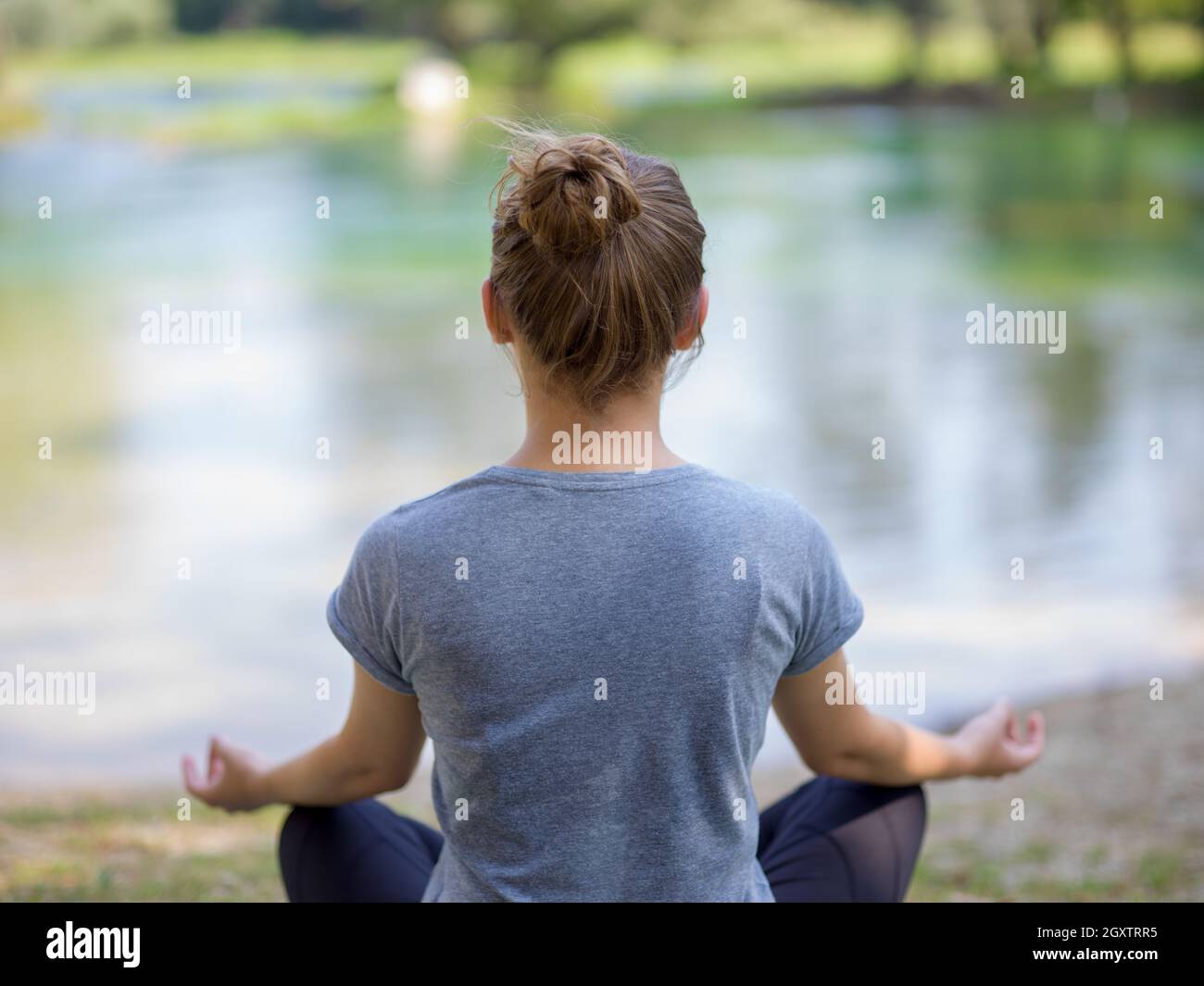 healthy woman relaxing while meditating and doing yoga exercise in the ...