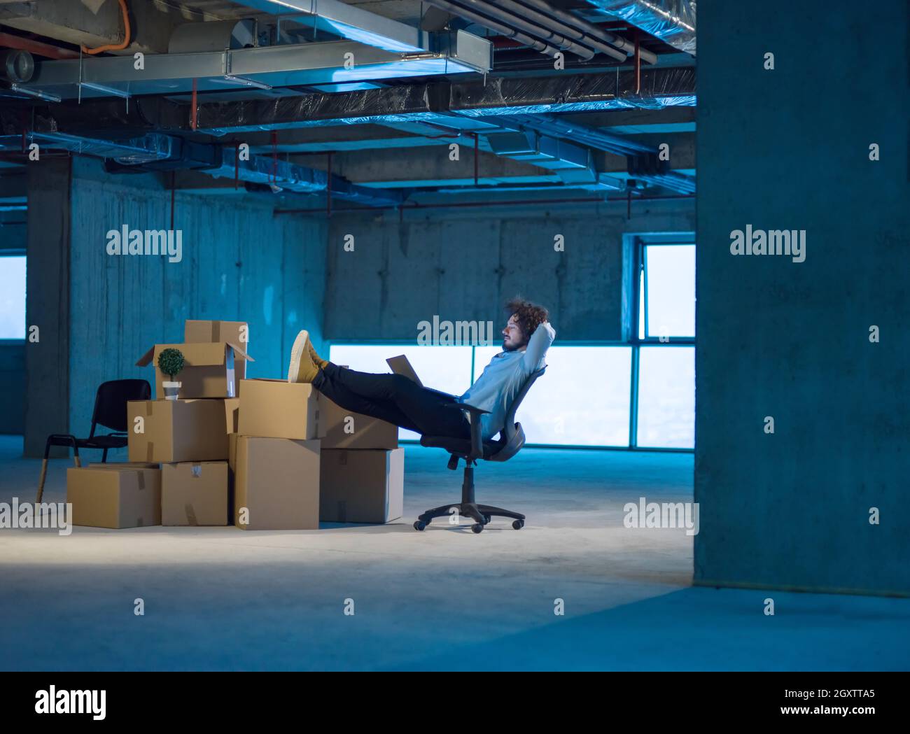 young male architect on construction site checking documents and ...