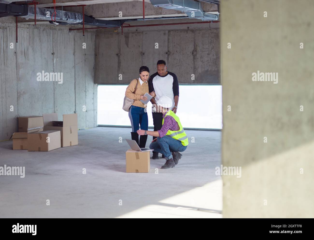 construction worker using laptop computer while showing house design ...