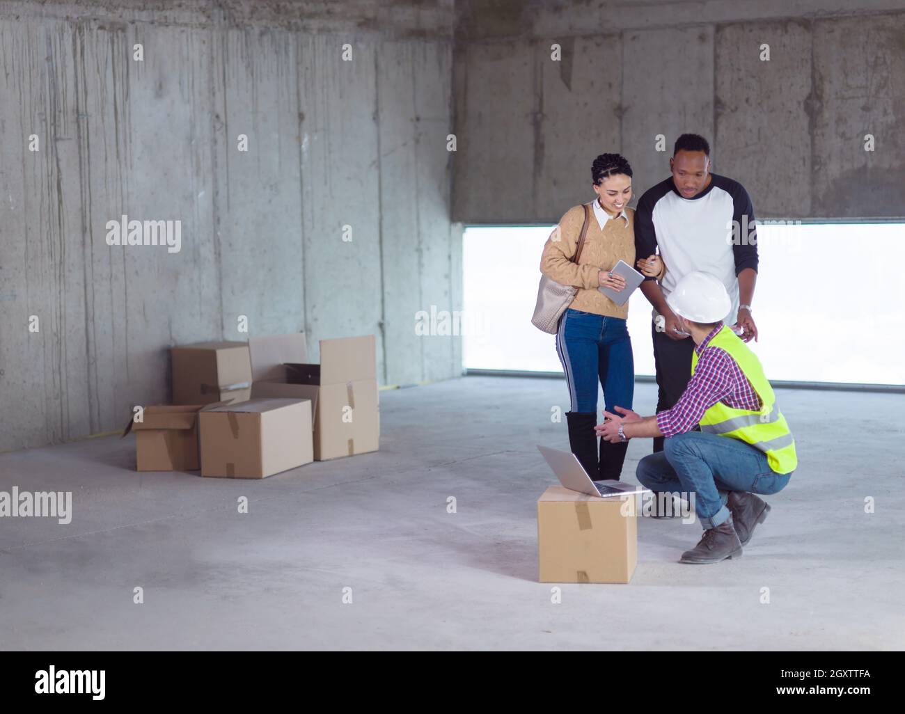 construction worker using laptop computer while showing house design ...