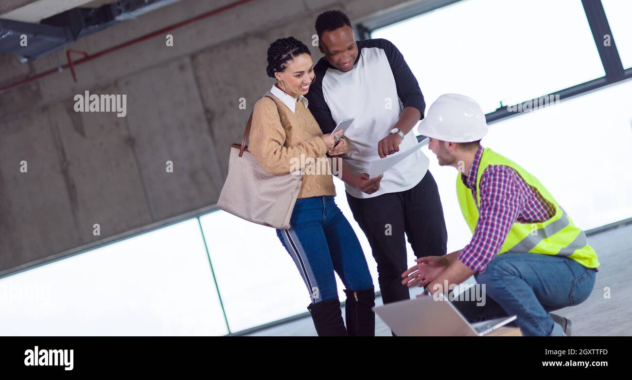 construction worker using laptop computer while showing house design ...