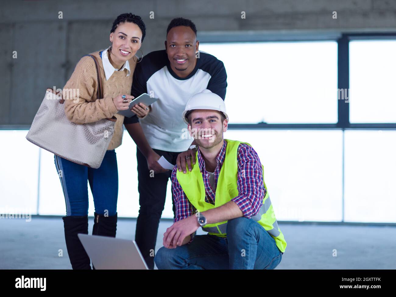 construction worker using laptop computer while showing house design ...