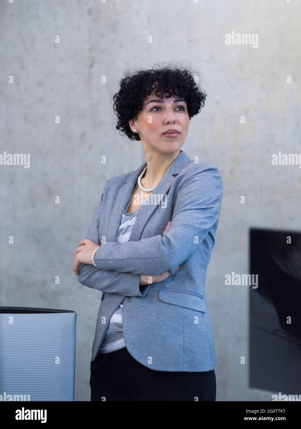 Portrait of successful female software developer with a curly hairstyle ...