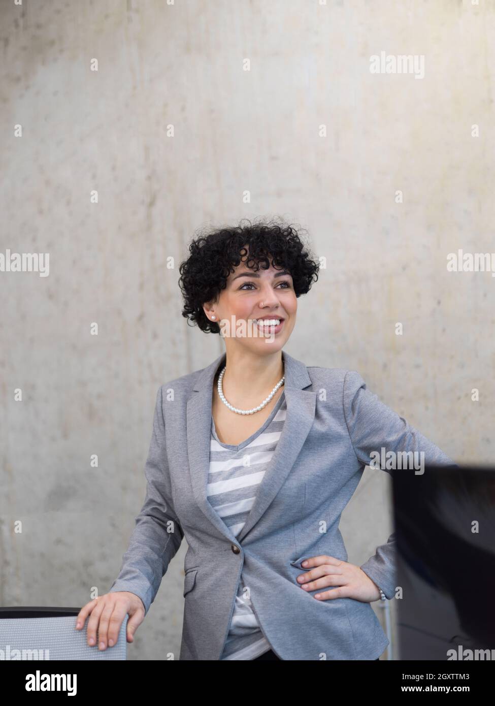 Portrait of successful female software developer with a curly hairstyle ...