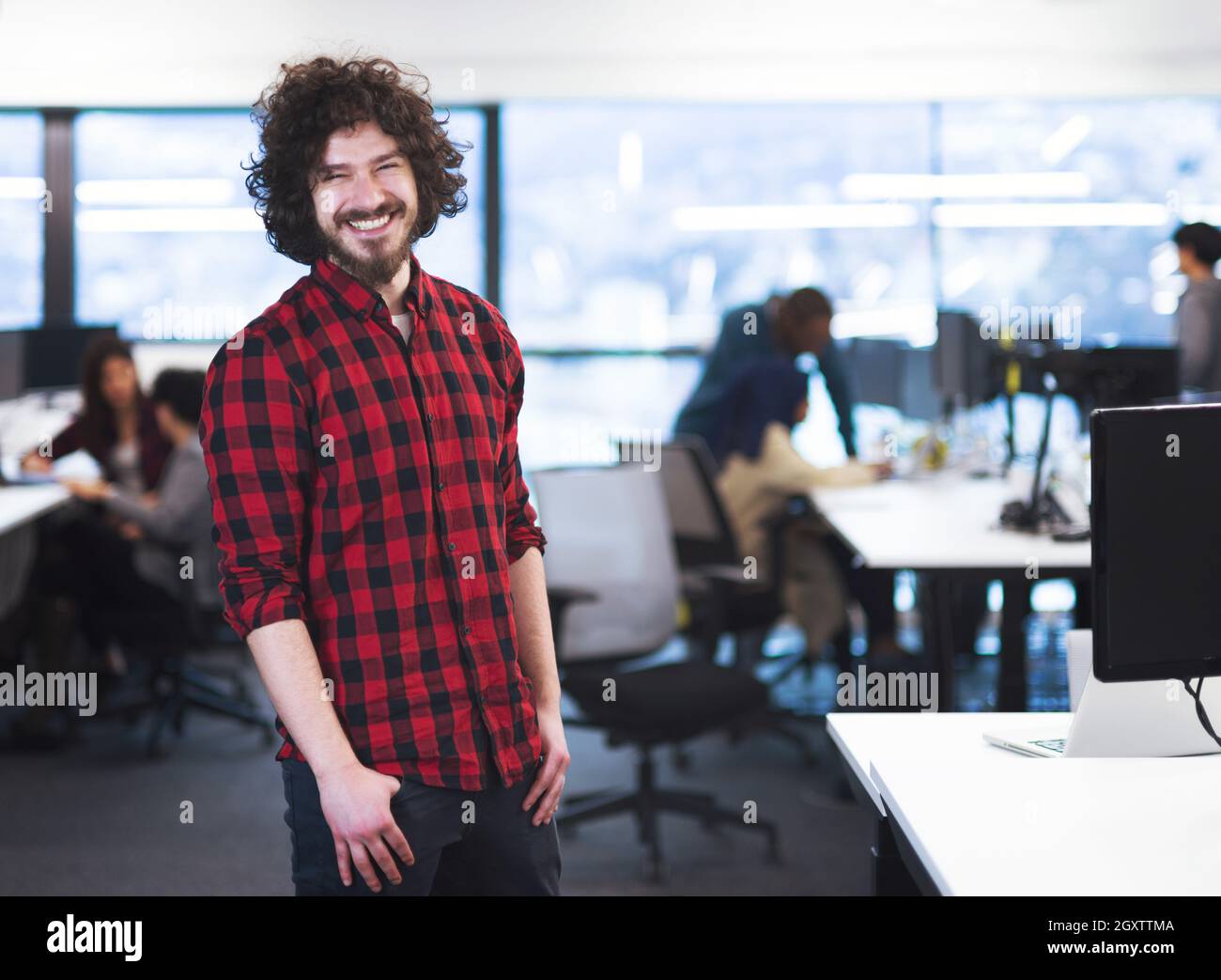 Portrait of young smiling successful male software developer standing ...