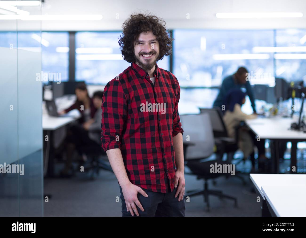 Portrait of young smiling successful male software developer standing ...