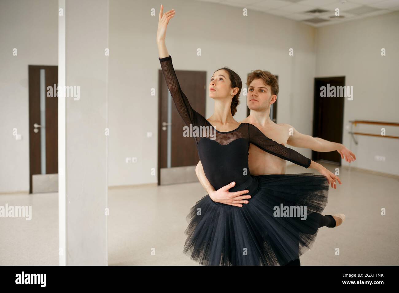 Female and male ballet dancers in action. Ballerina with partner ...