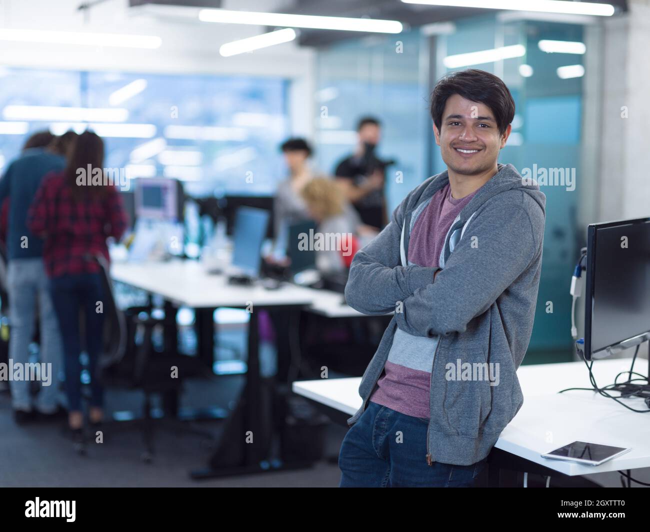 Portrait of young smiling successful male software developer standing ...