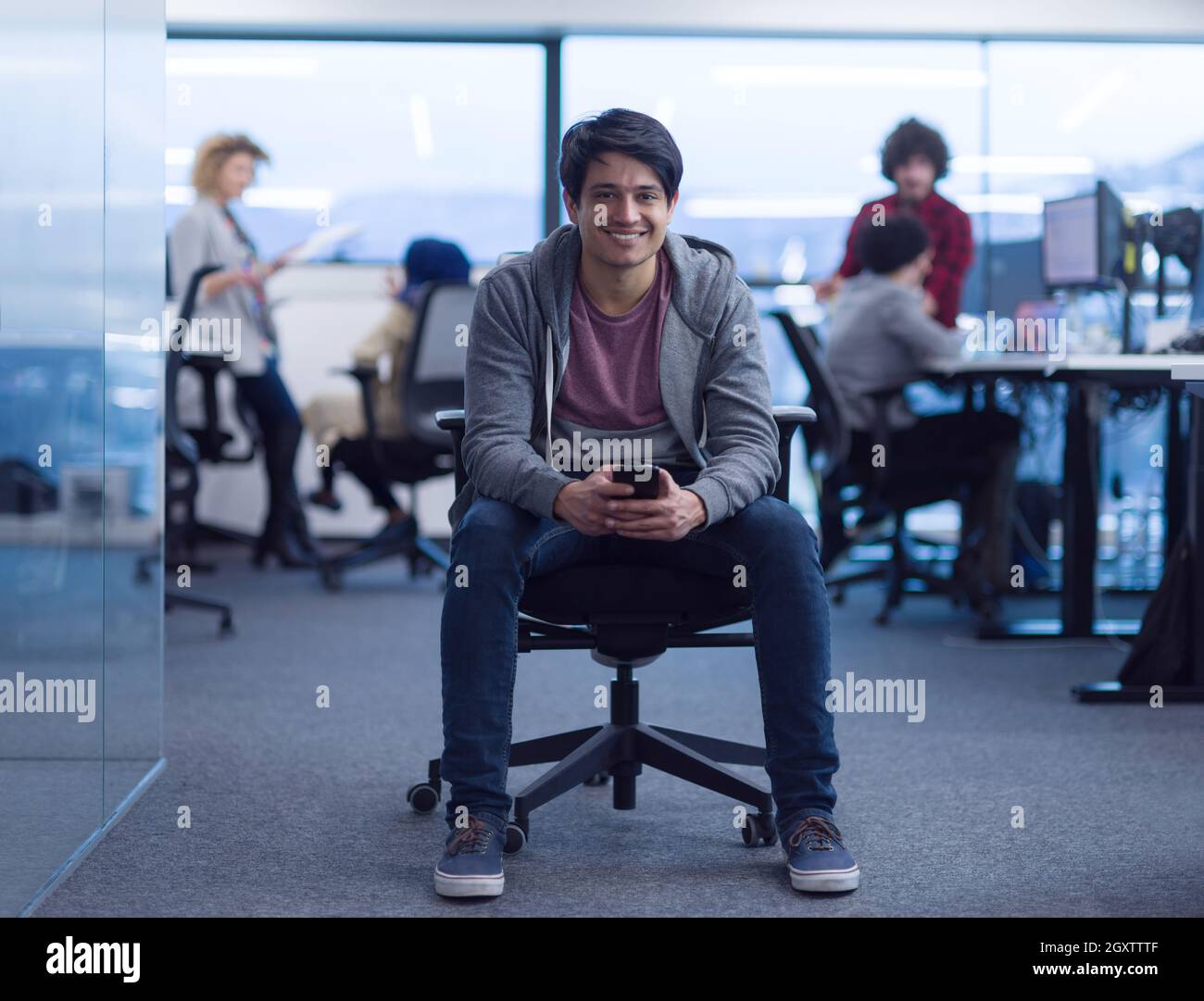 young indian male software developer using mobile phone writing ...