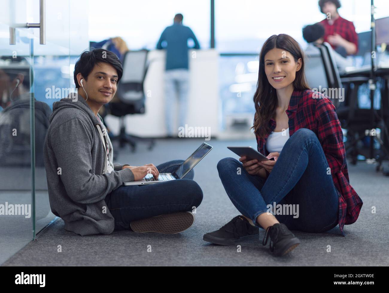 Young Software Developers Couple Using Laptop And Tablet Computer Writing Programming Code While