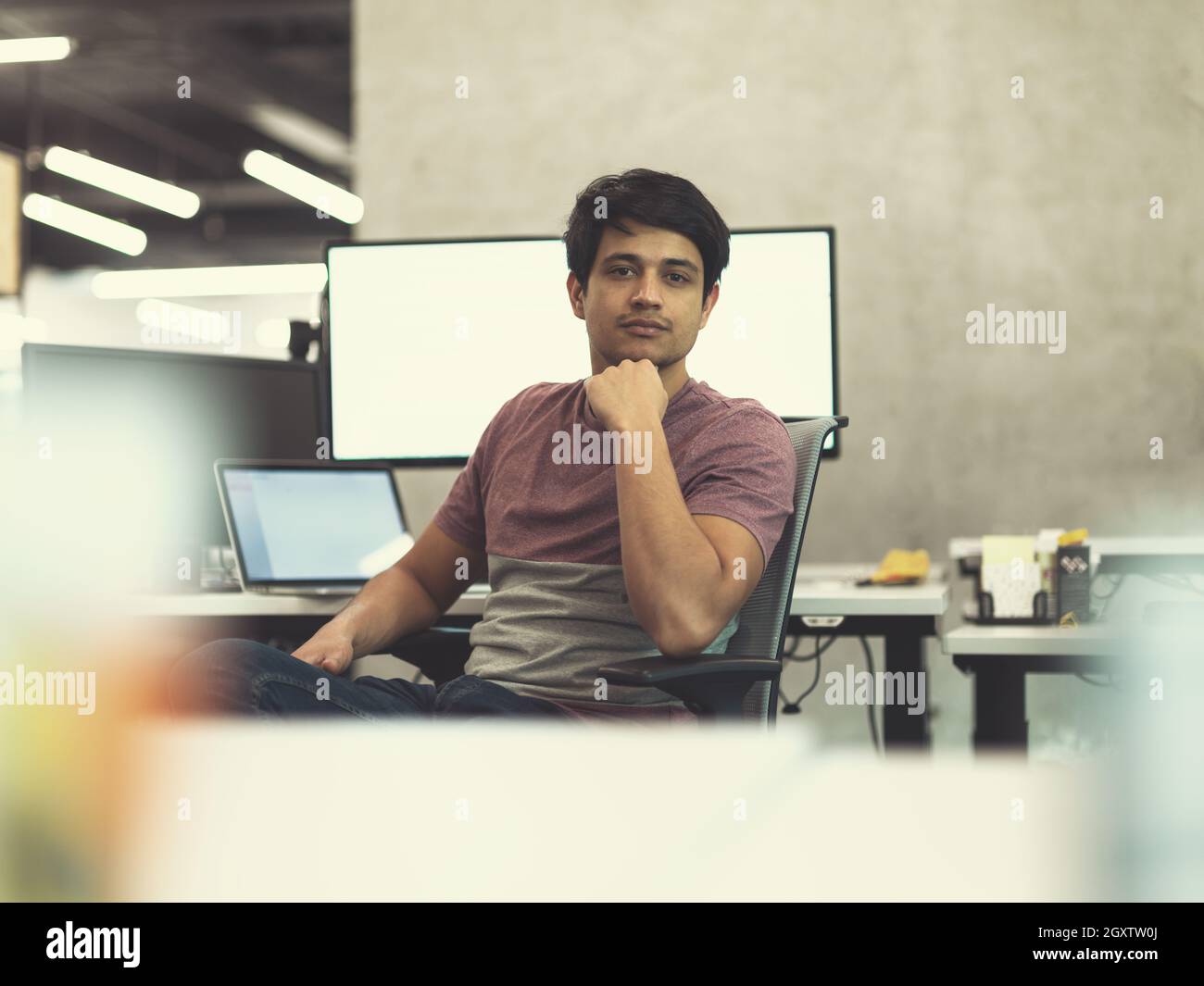 Portrait of young indian successful male software developer sitting on ...