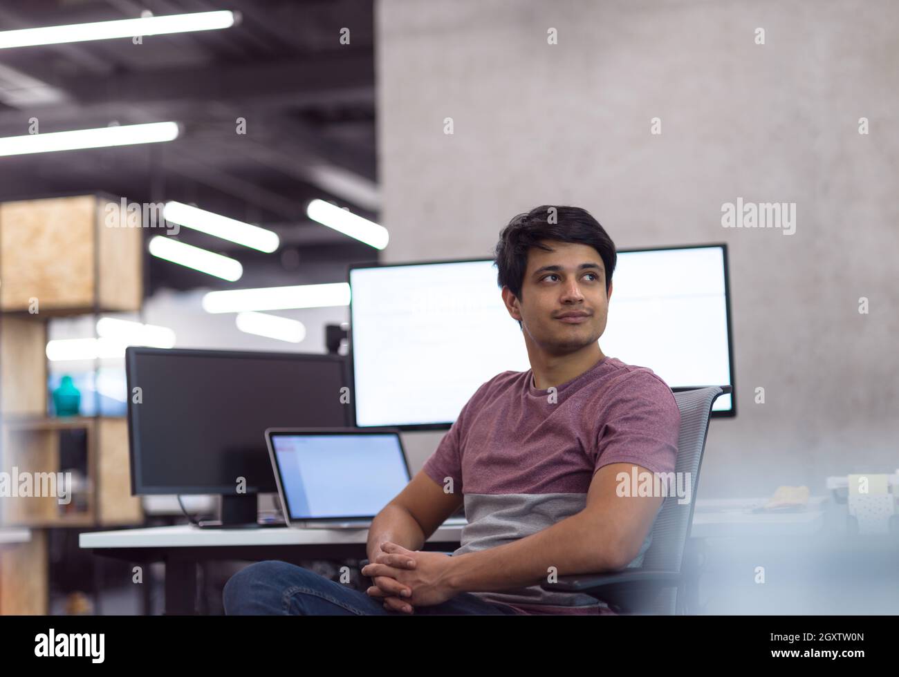 Portrait of young indian successful male software developer sitting on ...