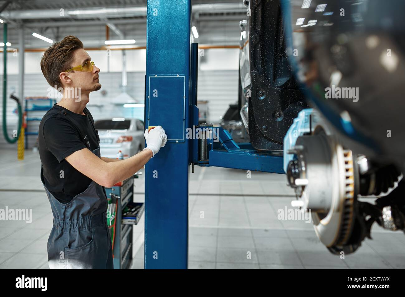 Man Lifts Car High Resolution Stock Photography and Images - Alamy