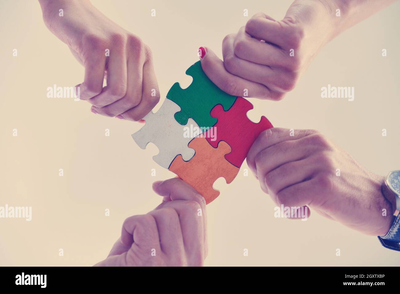 Group of business people assembling jigsaw puzzle and represent team ...