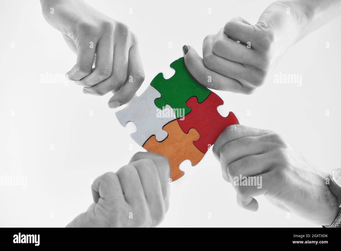 Group of business people assembling jigsaw puzzle and represent team ...