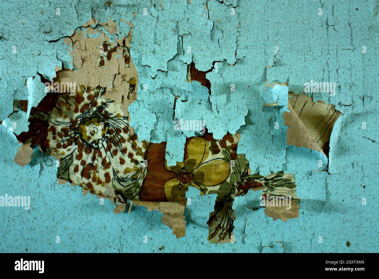 An old mural is revealed behind crumbling teal paint Stock Photo - Alamy